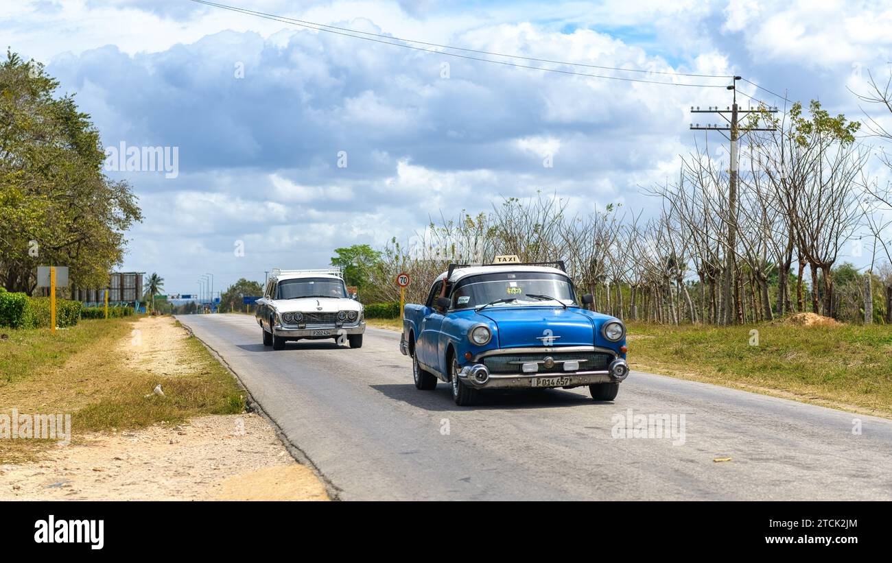 Vintage American car driving in rural road, Cuba Stock Photo - Alamy