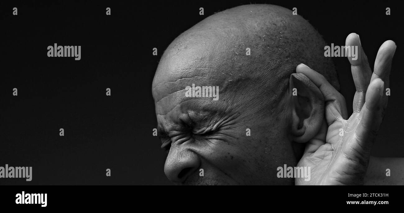 deafness suffering from hearing loss on grey black background with ...