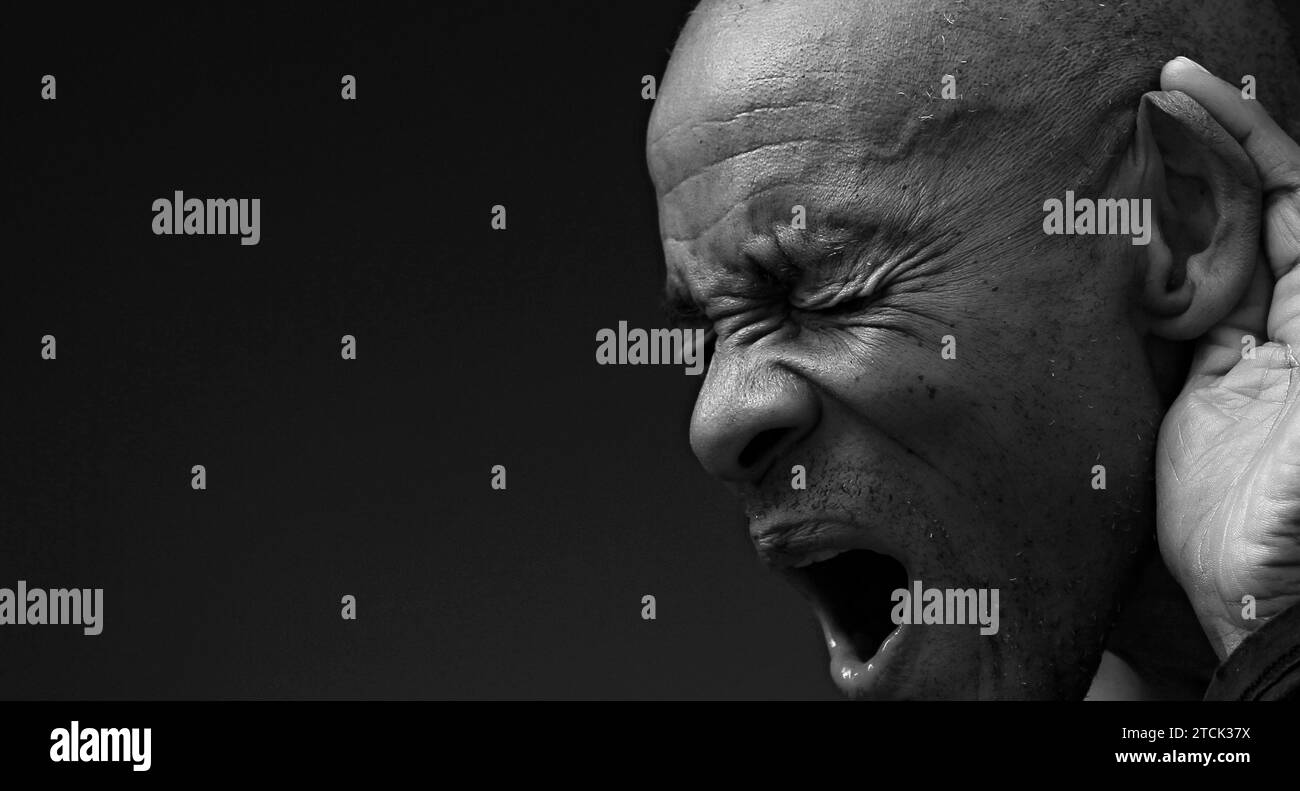 deafness suffering from hearing loss on grey black background with ...