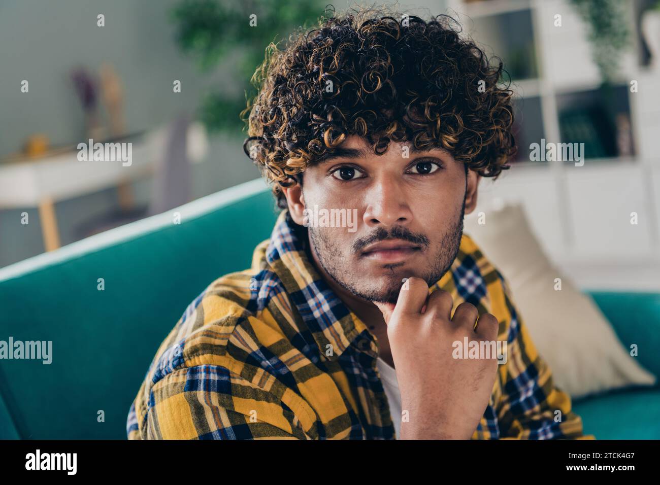 Portrait of pensive intelligent person sit sofa arm touch chin ...