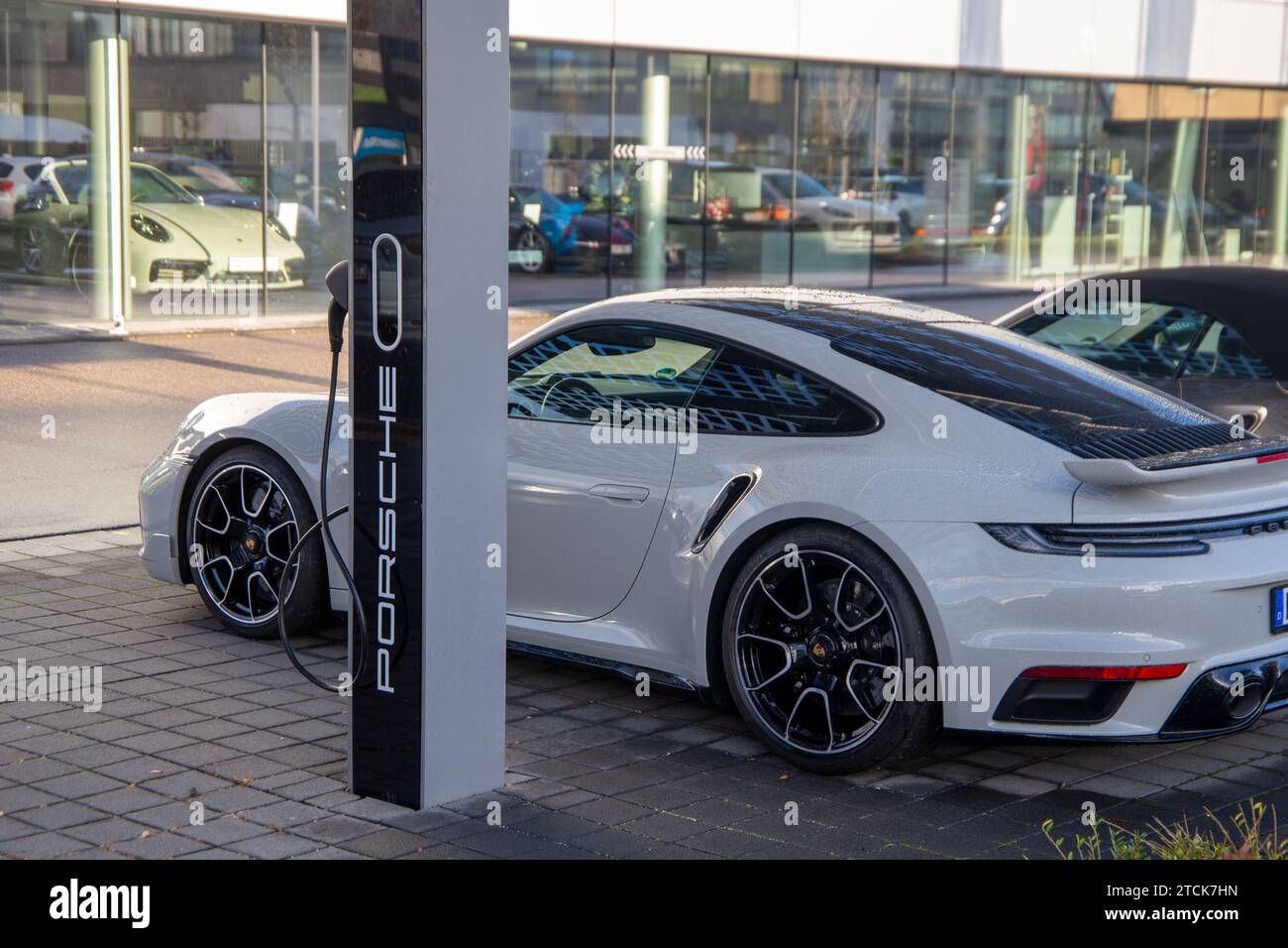 Porsche at a charging station for electric cars at the Porsche Centre ...