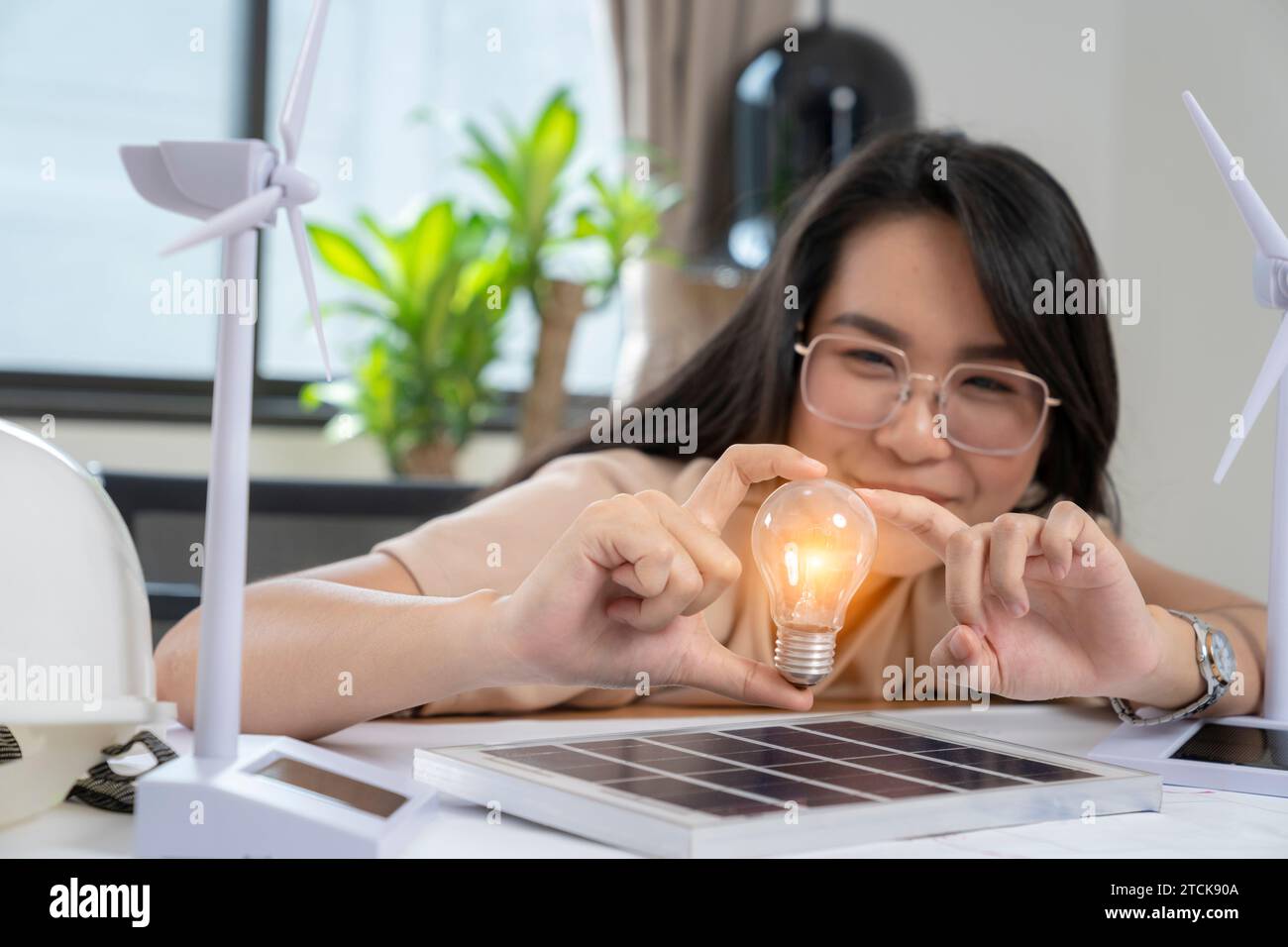 A young woman experimenting with using renewable energy from sunlight ...