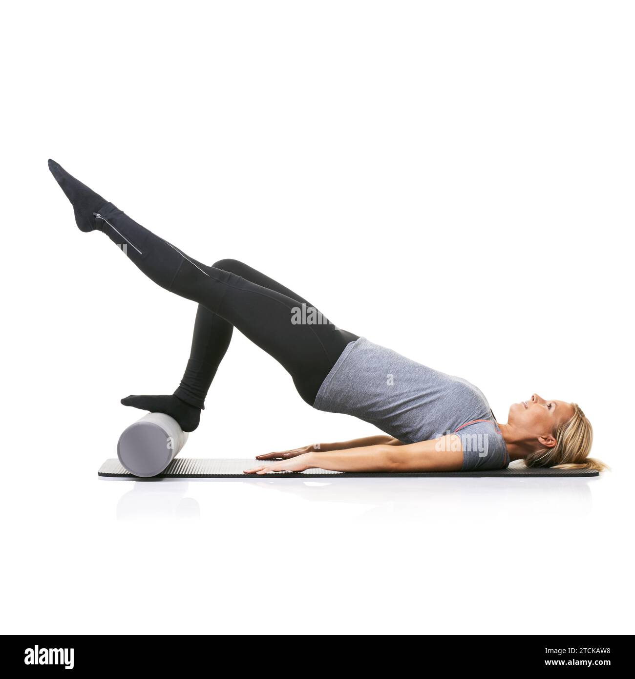 Legs workout, foam roller and studio woman with bridge exercise ...