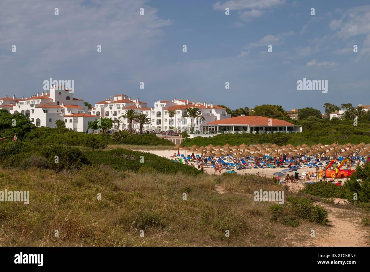 Tourists enjoy the beach in the resort of Cala en Bosc on the Spanish ...