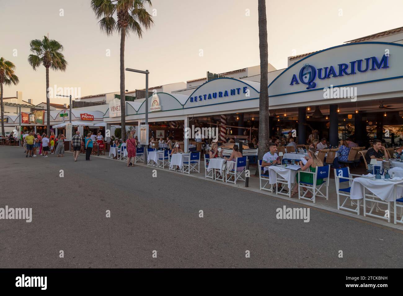 Cozy restaurants on the harbor in the seaside resort of Cala en Bosc on ...