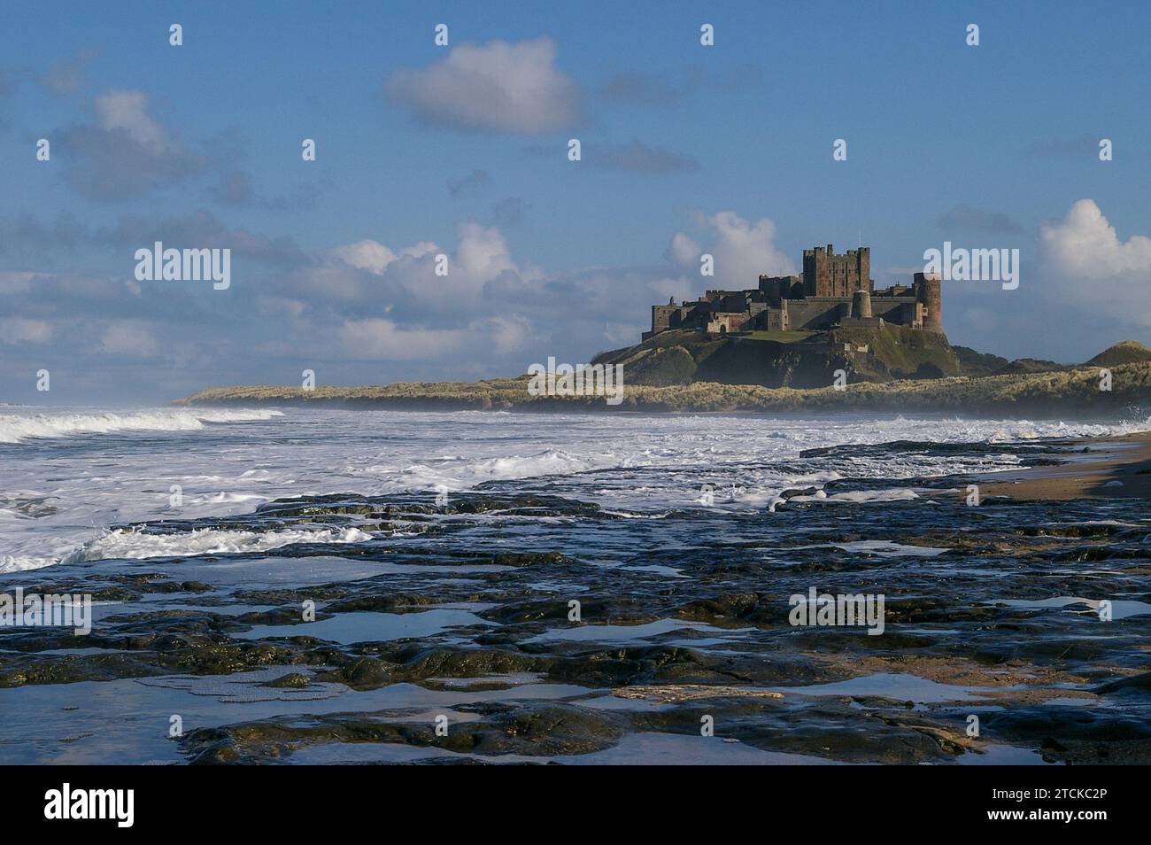 Historic Bamburgh Castle standing on a rocky outcrop on the North East ...