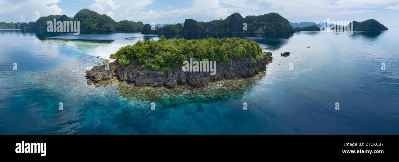 Limestone islands rise from the seascape in Raja Ampat, Indonesia ...