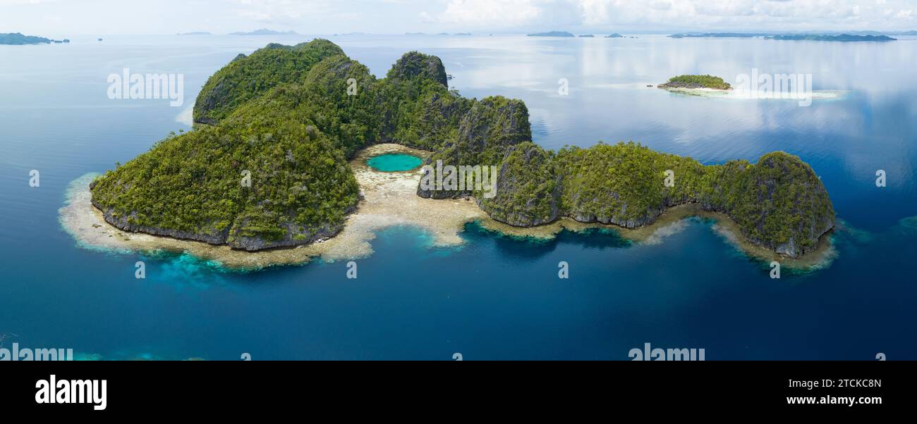 Limestone islands rise from the seascape in Raja Ampat, Indonesia ...