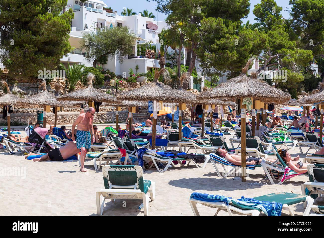 People enjoy the beautiful beach of the resort of Cala d'Or on the ...