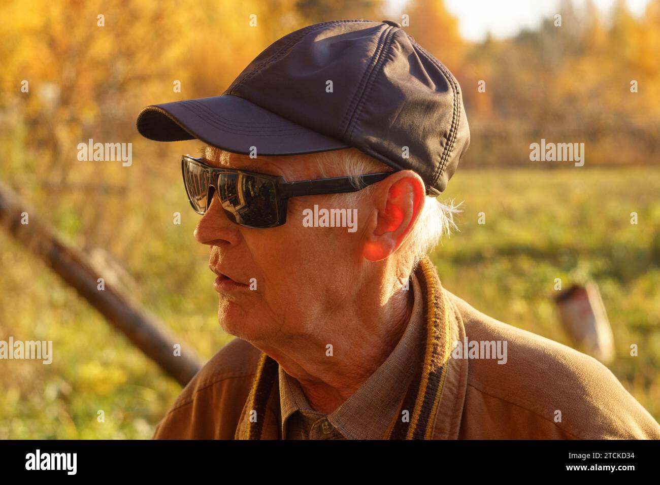 Portrait of an old man wearing sun protection glasses. Old grey haired ...