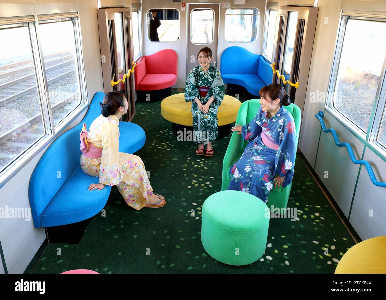 Female passengers clad in a yukata, a summer kimono take a footbath ...