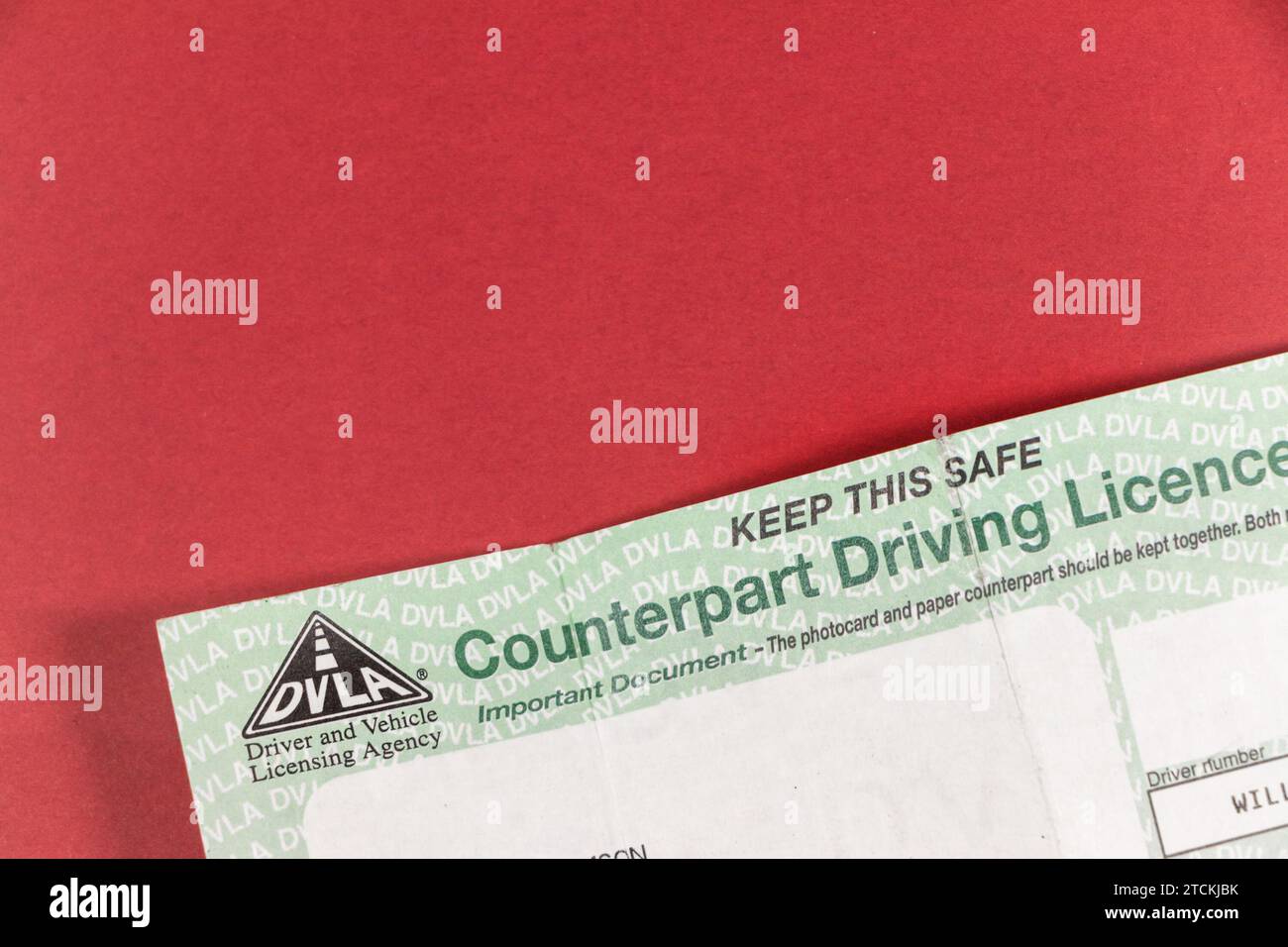 old paper uk counterpart driving licence detail isolated on red studio ...
