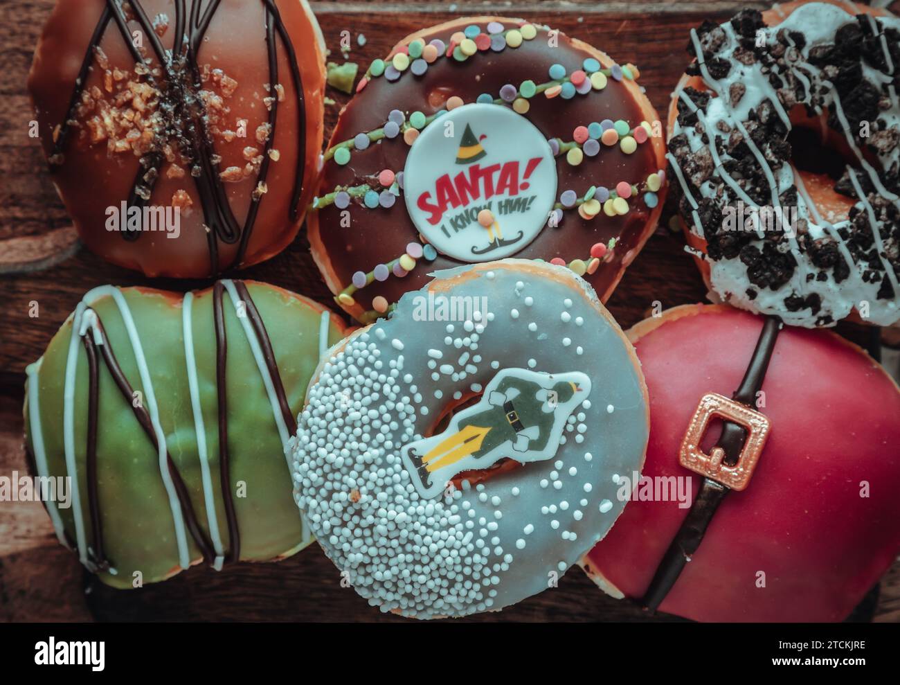 Many Glazed Doughnuts placed on wooden cutting board. The concept of ...