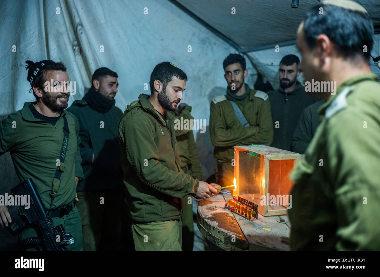 13 December 2023, ---: Israeli soldiers light candles for Hanukah near ...