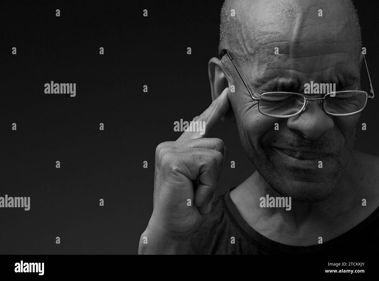 deafness suffering from hearing loss on grey black background with ...