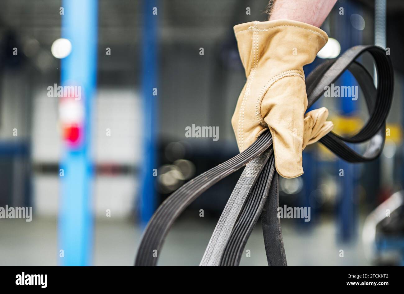 Car Mechanic with a Brand New Serpentine Belt in His Hands. Drive Belt ...