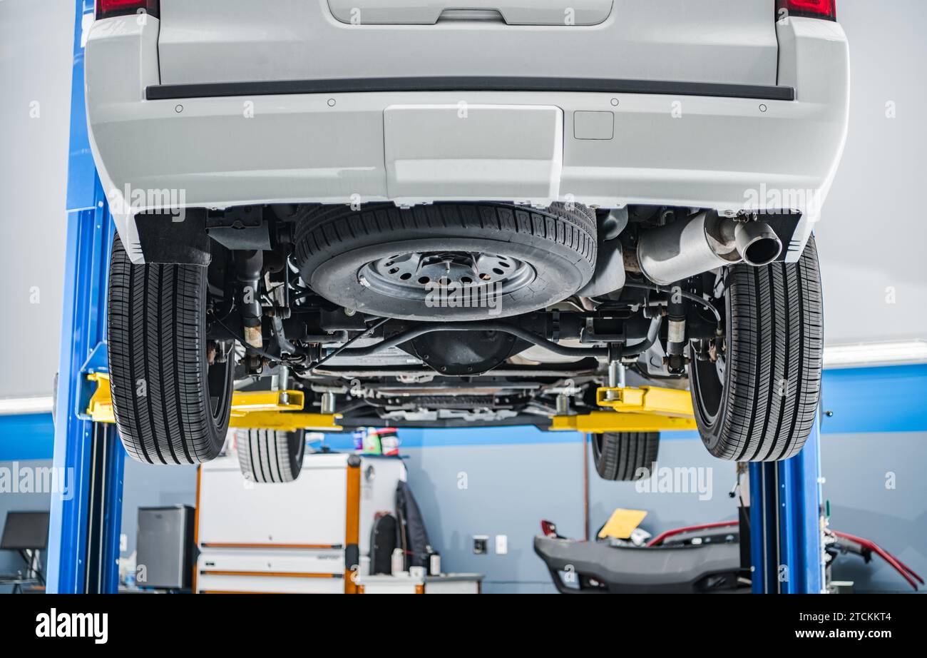 Automotive Industry Theme. Modern Car on a Lift Inside Auto Service ...