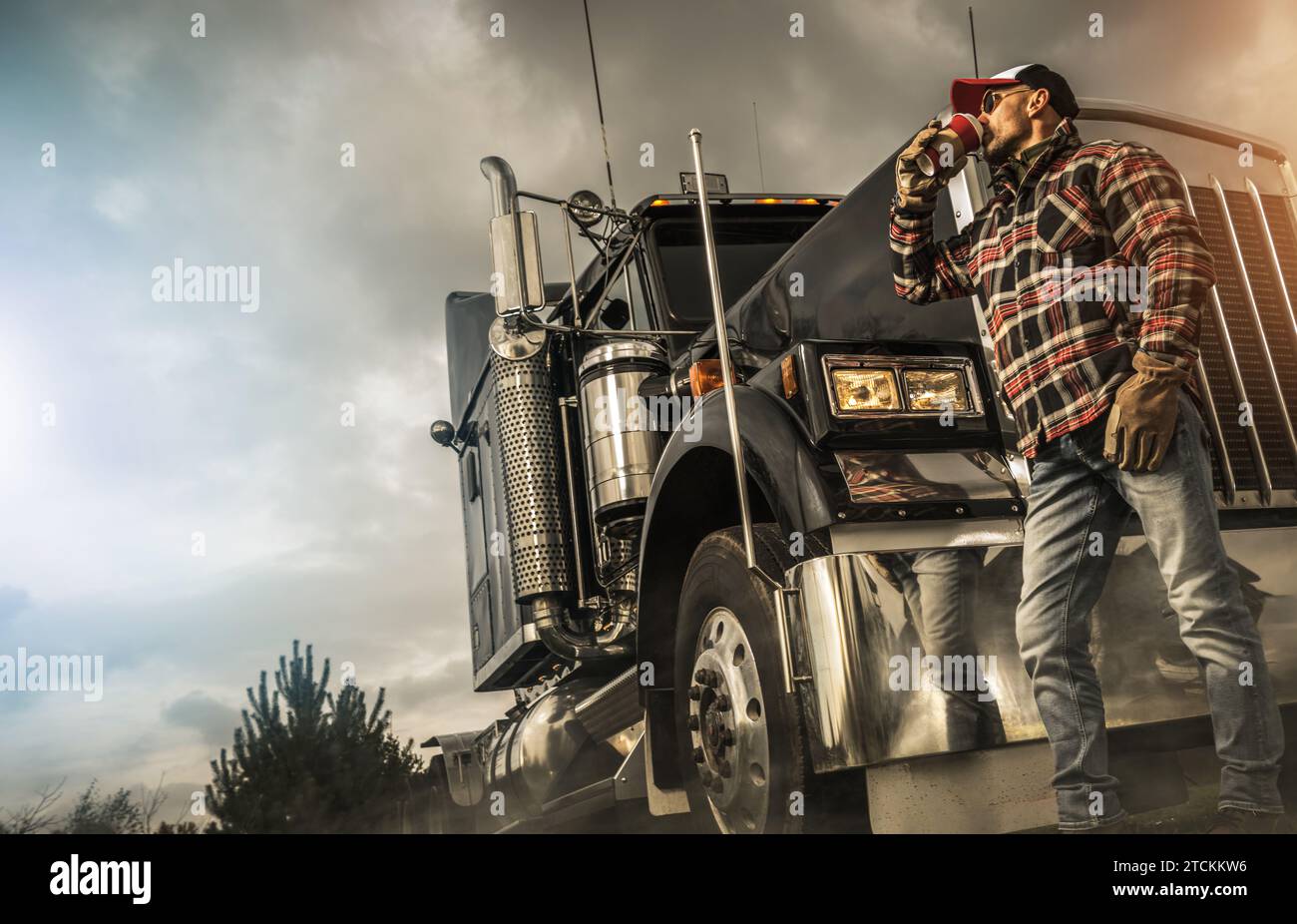 Professional Commercial Driver Drinking Hot Coffee in Front or His Semi ...