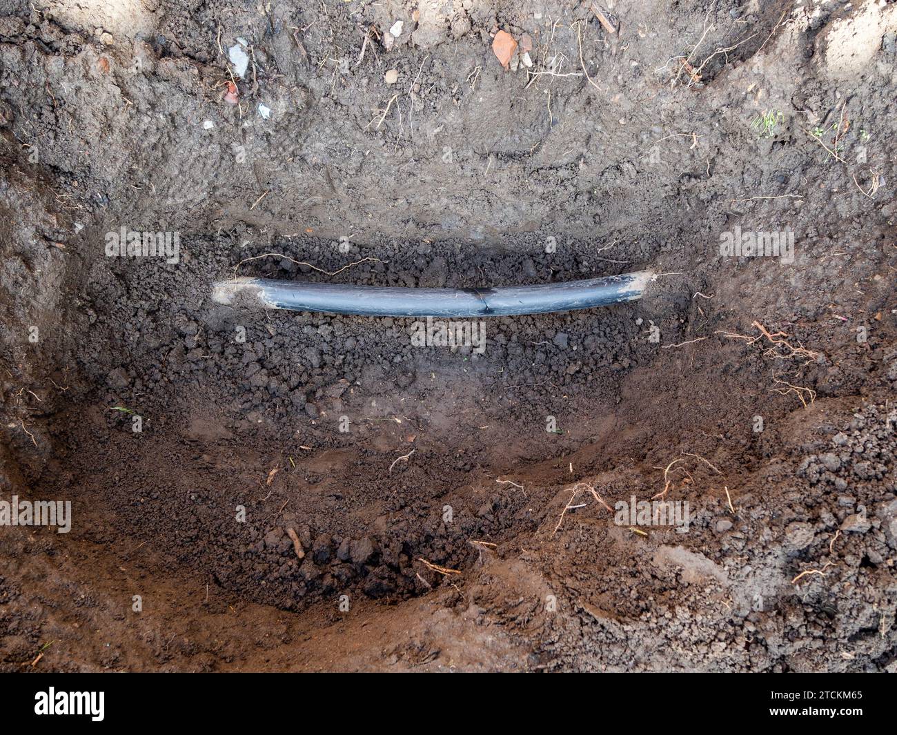 plastic water pipe damaged by shovel in ground when digging hole in ...