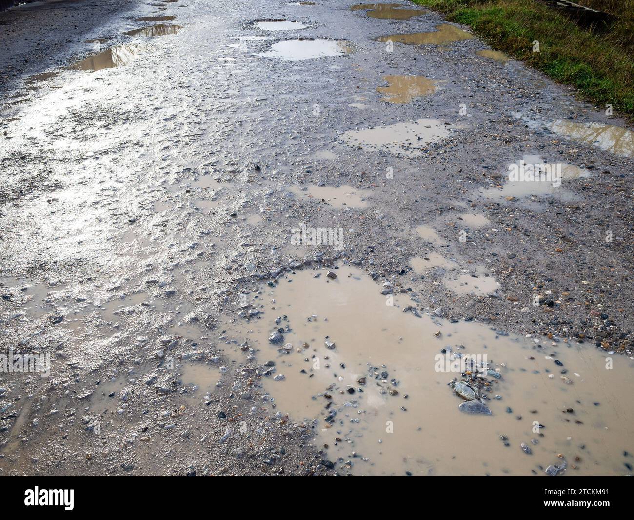 surface of wet dirty gravel road with puddles in village after rain on autumn day Stock Photo ...