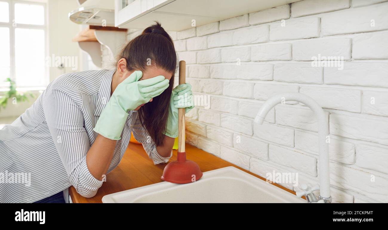 Sad Woman Facing Sink Blockage with Plunger Stock Photo - Alamy