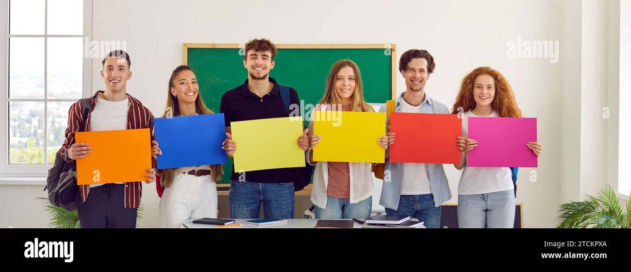 Group of happy school, college or university students showing colorful ...