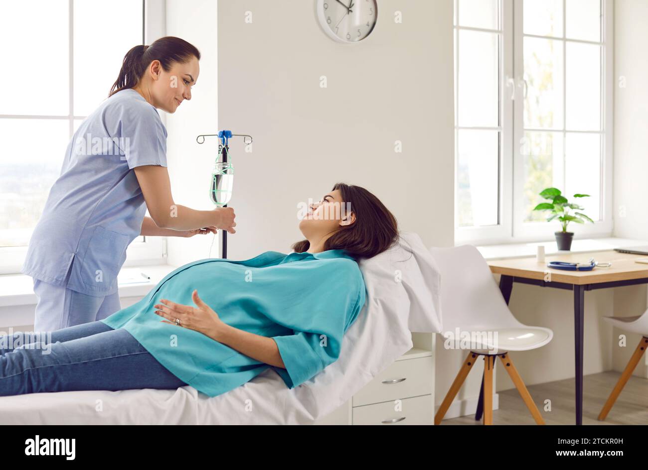 Doctor or nurse assistant put dropper on pregnant woman to improve her ...