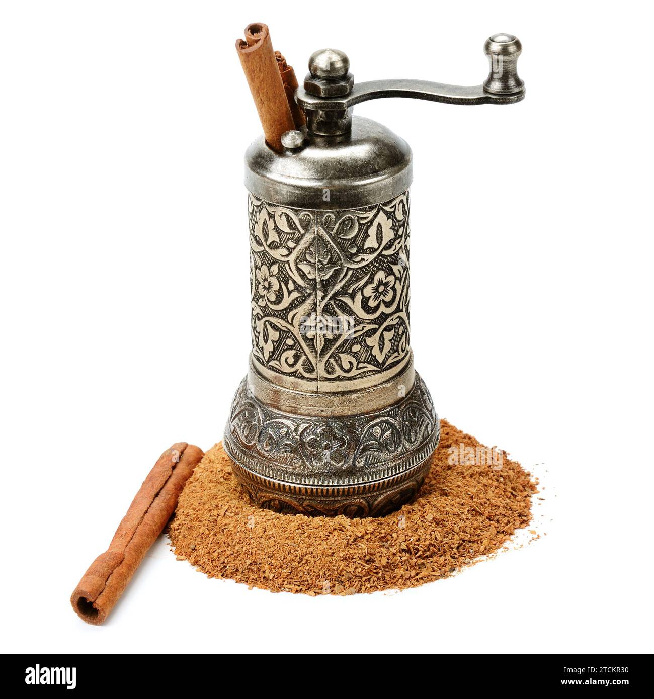 Cinnamon and manual grinder isolated on white background. Useful spice ...