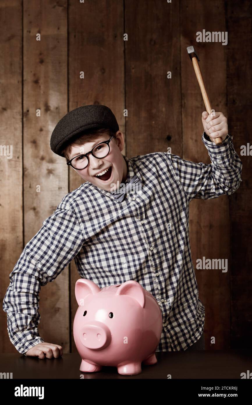Hammer, portrait and boy child with piggy bank, savings or investment ...