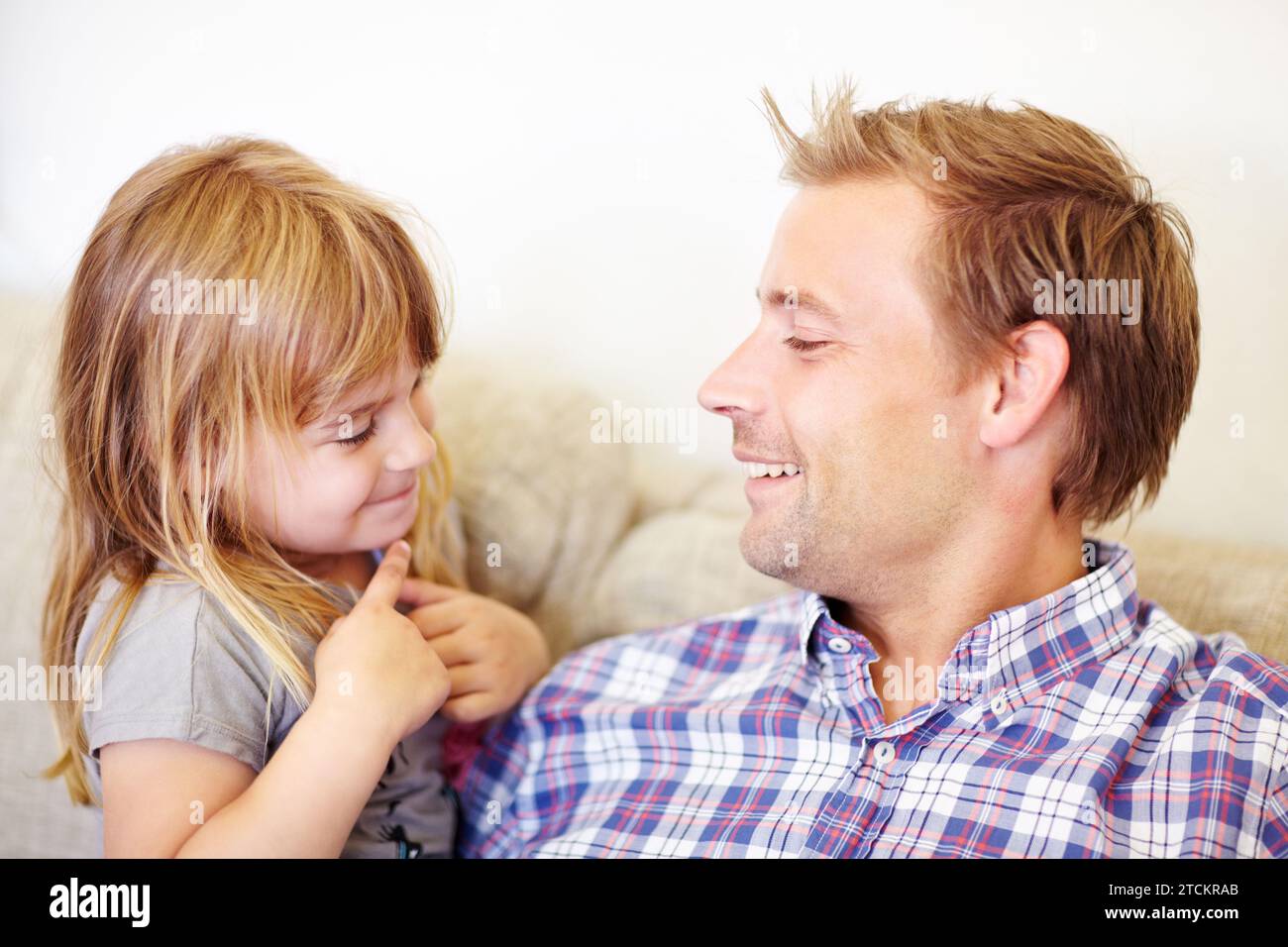 Smile, conversation and father with child on a sofa relaxing, talking ...