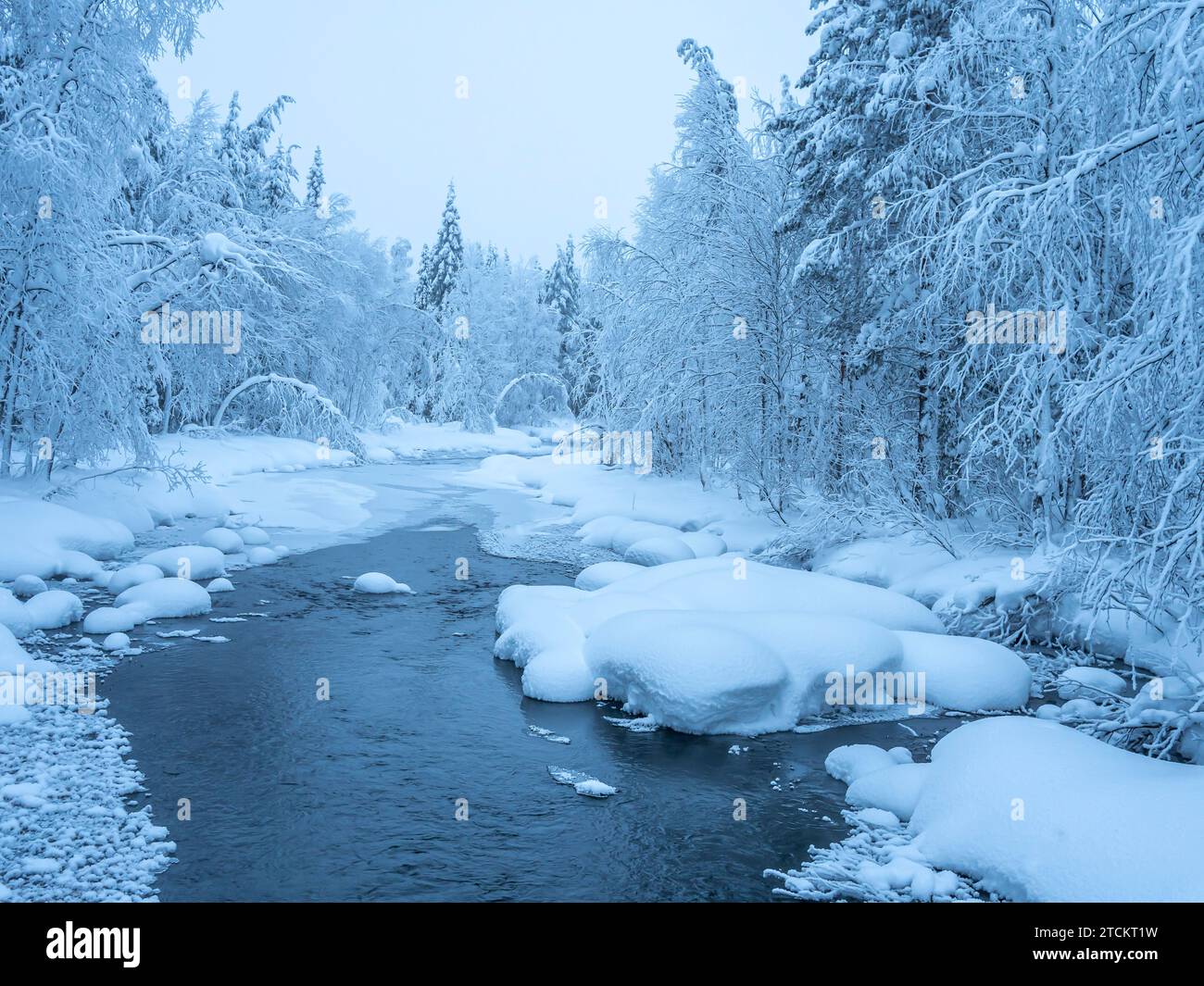 River flowing through a snowy winter landscape, Lapland, Finland Stock ...