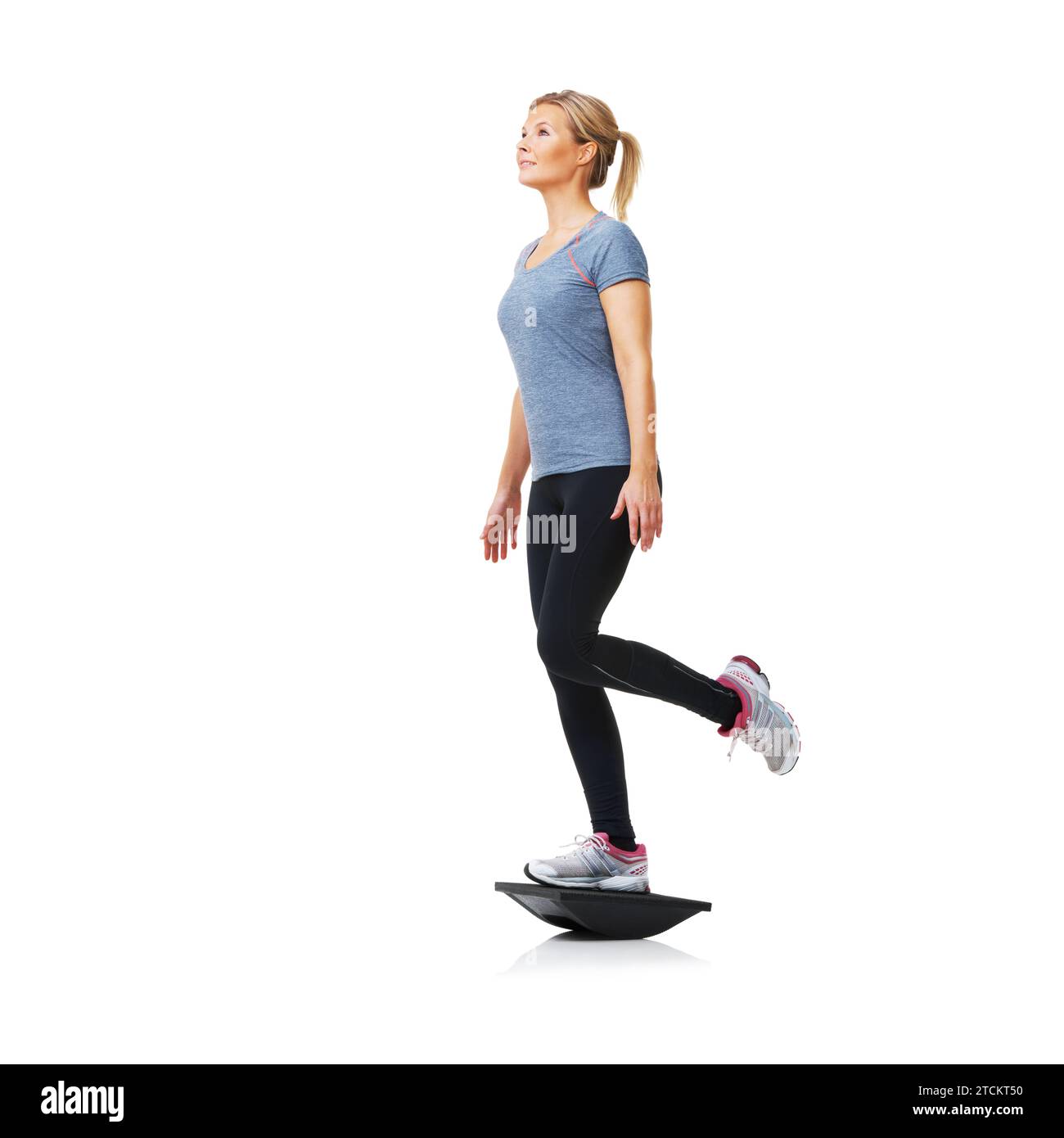 Fitness, board and balance exercise with a woman in studio isolated on ...