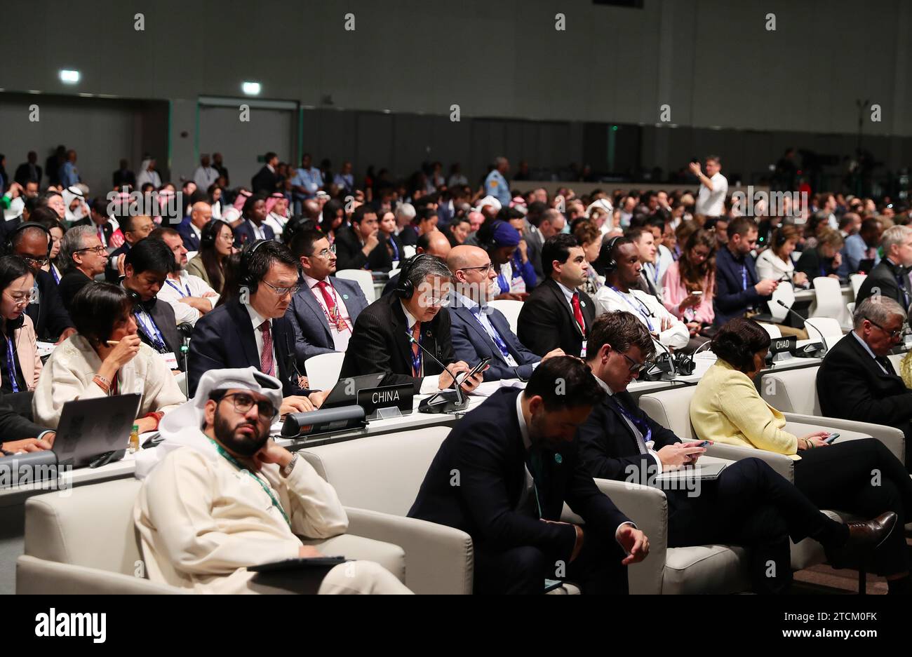 Dubai, United Arab Emirates. 13th Dec, 2023. Attendees are seen during ...