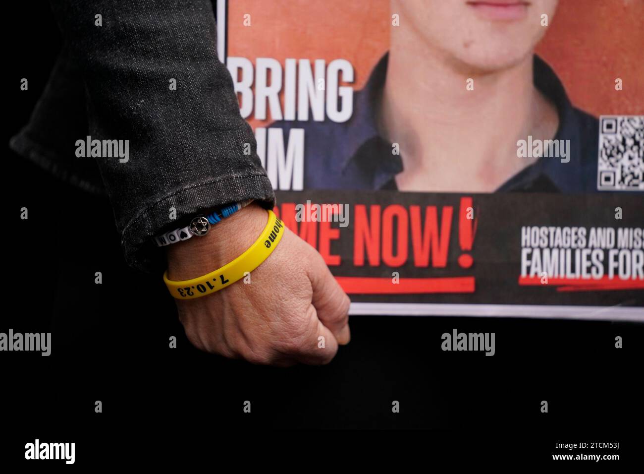 Orna Neutra, mother of Omer Neutra, holds a poster with an image of her ...