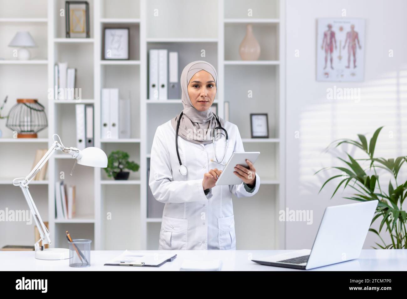Close-up portrait of Arabic female doctor in hijab and white medical ...