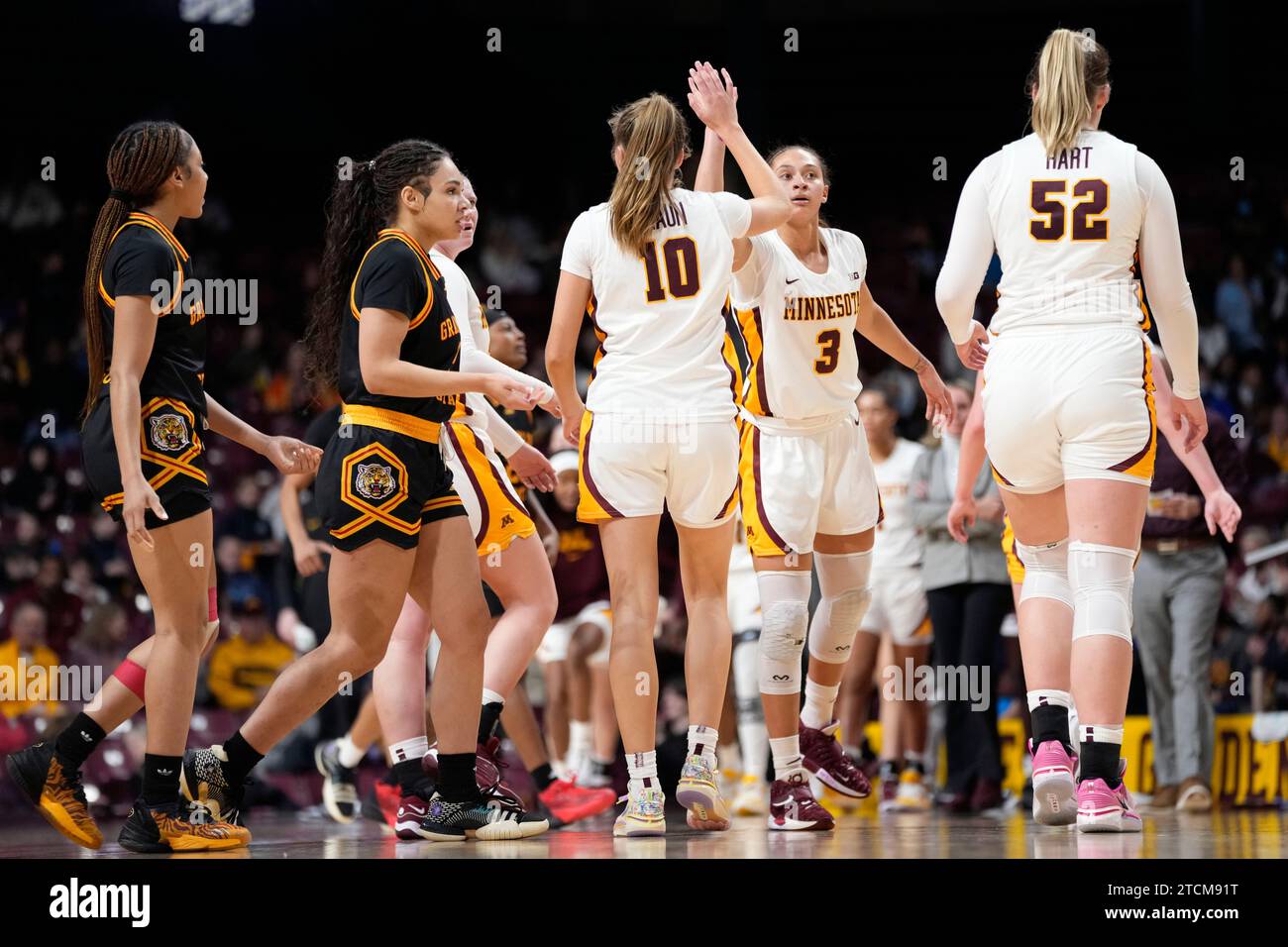 Minnesota guard Mara Braun (10) high fives guard Amaya Battle (3) after ...