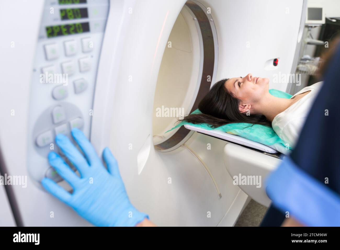 Pretty, young woman goiing through a Computerized Axial Tomography CAT ...