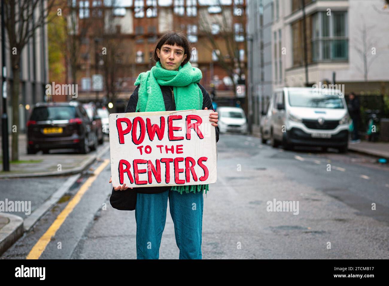 Female protester holding sign power to the renters in London , UK Stock ...