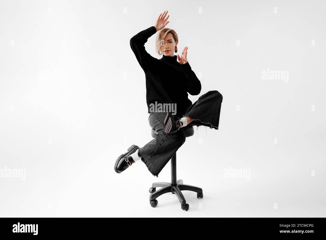 Woman in Creative Pose on Office Chair Stock Photo - Alamy