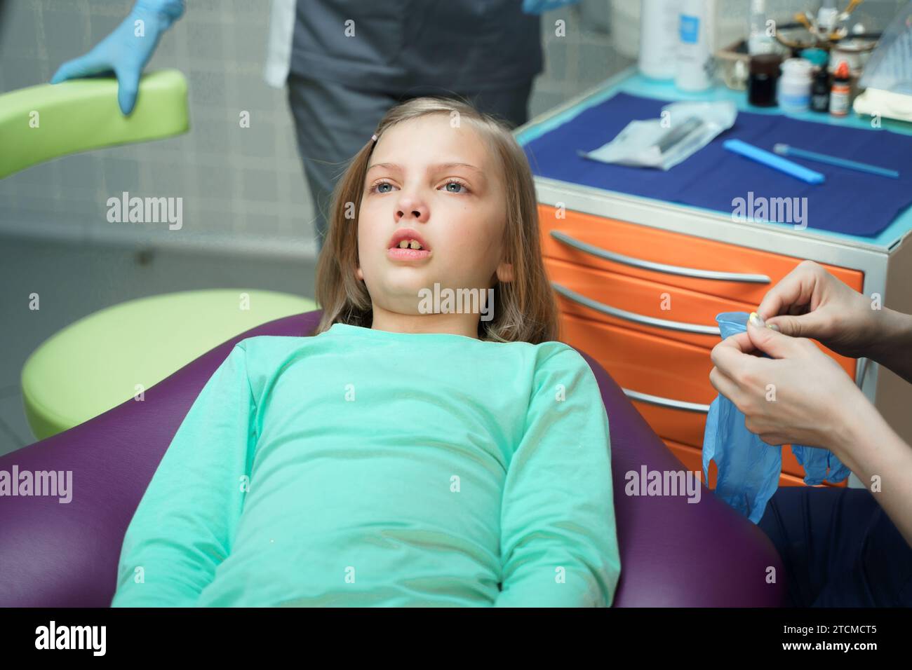 Little scared girl sitting in chair in dentist doctor office. Kid,child ...