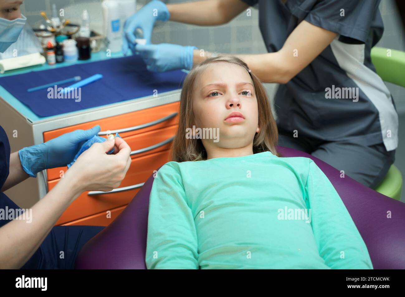 Little scared girl sitting in chair in dentist doctor office. Kid,child ...