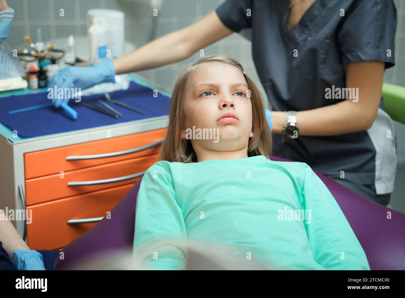 Little scared girl sitting in chair in dentist doctor office. Kid,child ...