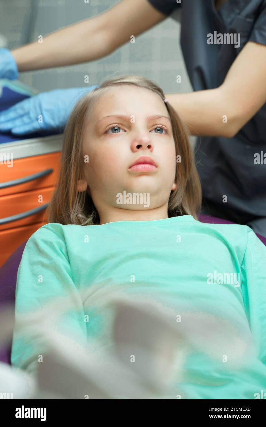 Little scared girl sitting in chair in dentist doctor office. Kid,child ...