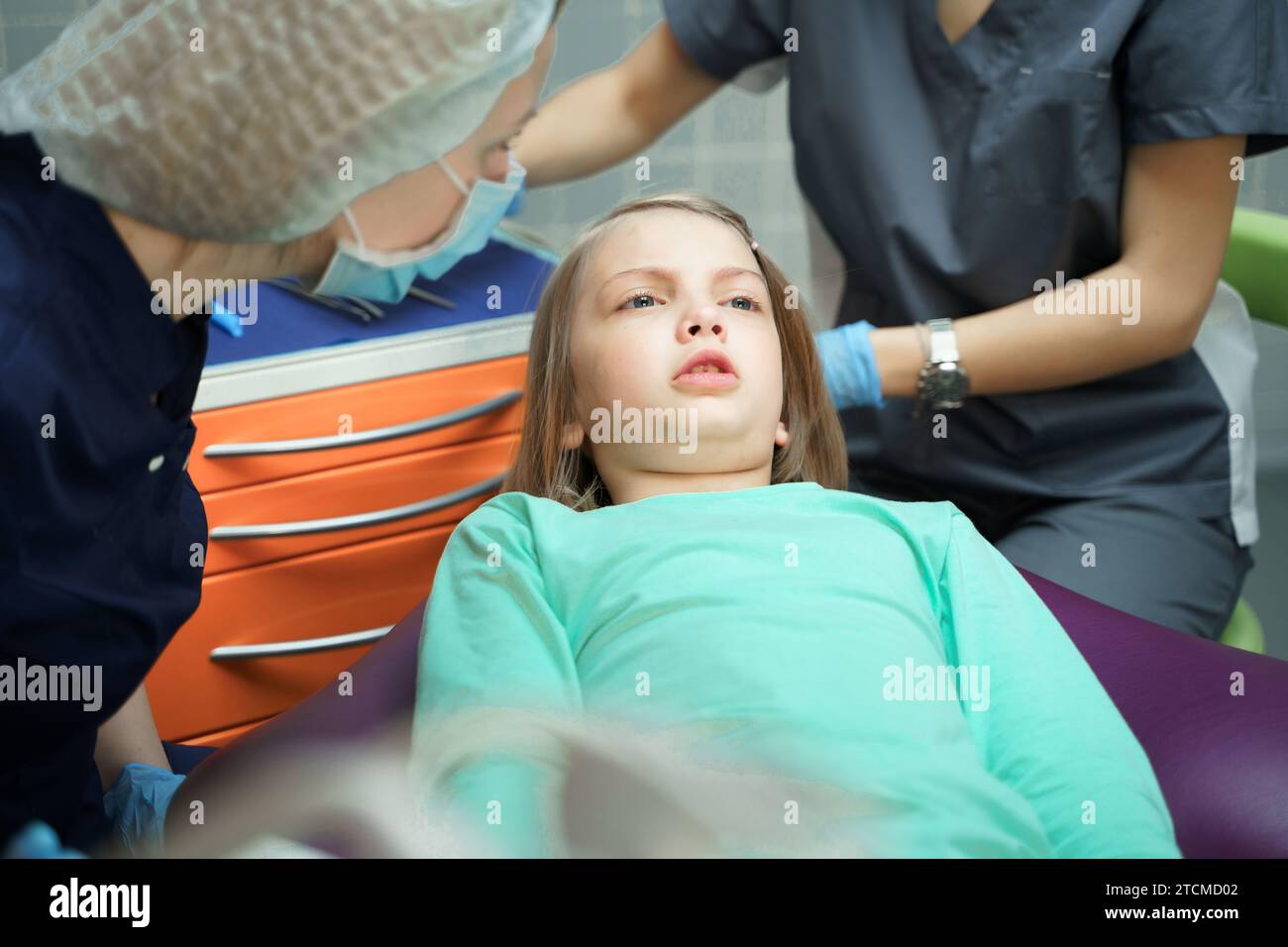 Little scared girl sitting in chair in dentist doctor office. Kid,child ...