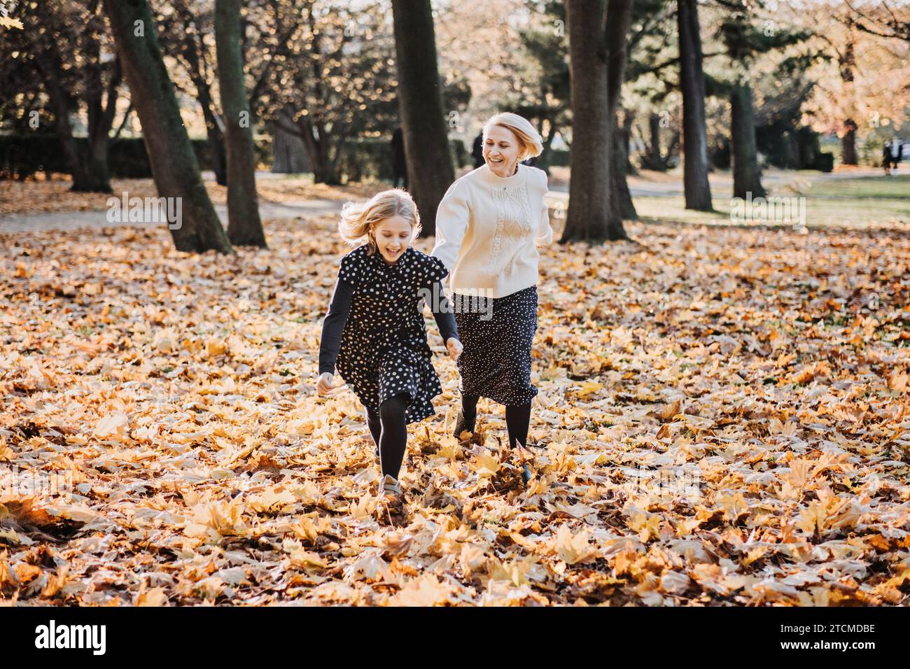 Autumn family walk. Heartwarming moment of smiling mother lovingly ...