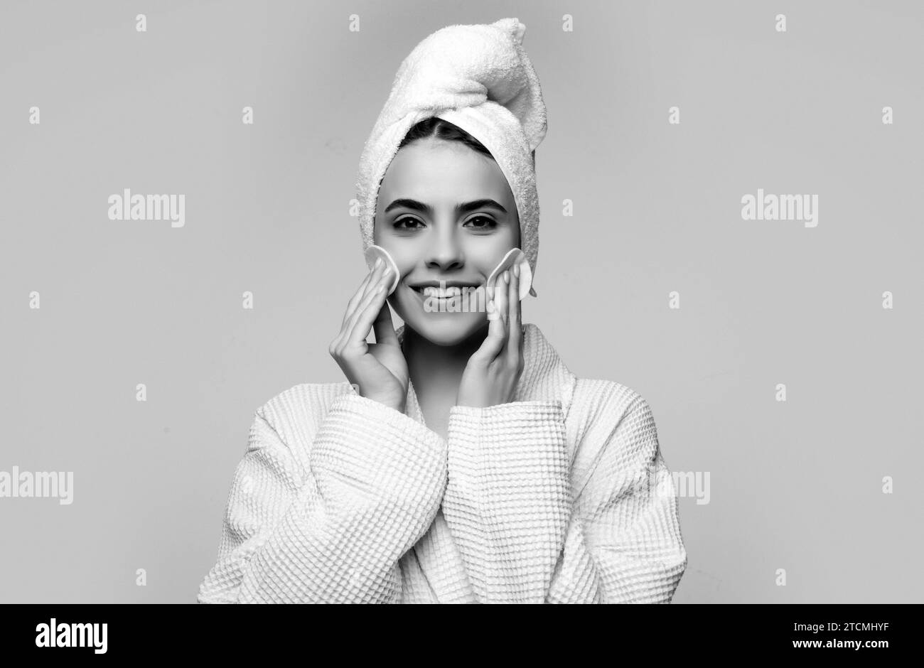 Beautiful young woman touching her face with sponge and smiling Stock ...