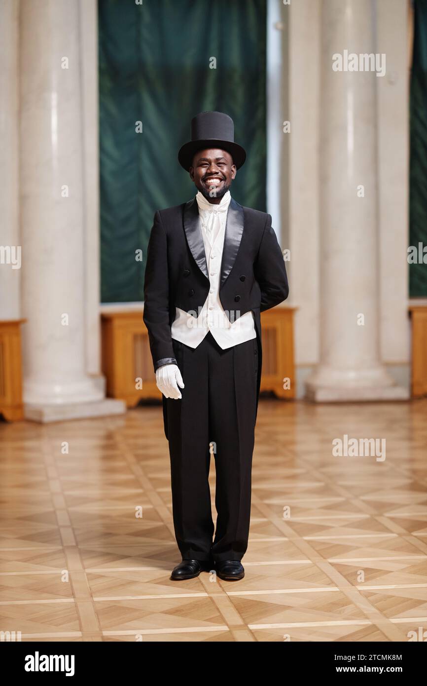 Full length portrait of smiling African American gentleman looking at ...