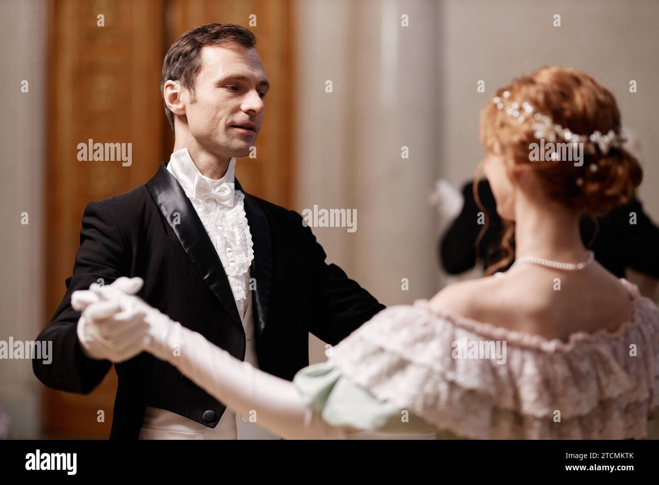 Waist up portrait of classic gentleman dancing waltz with lady in ...