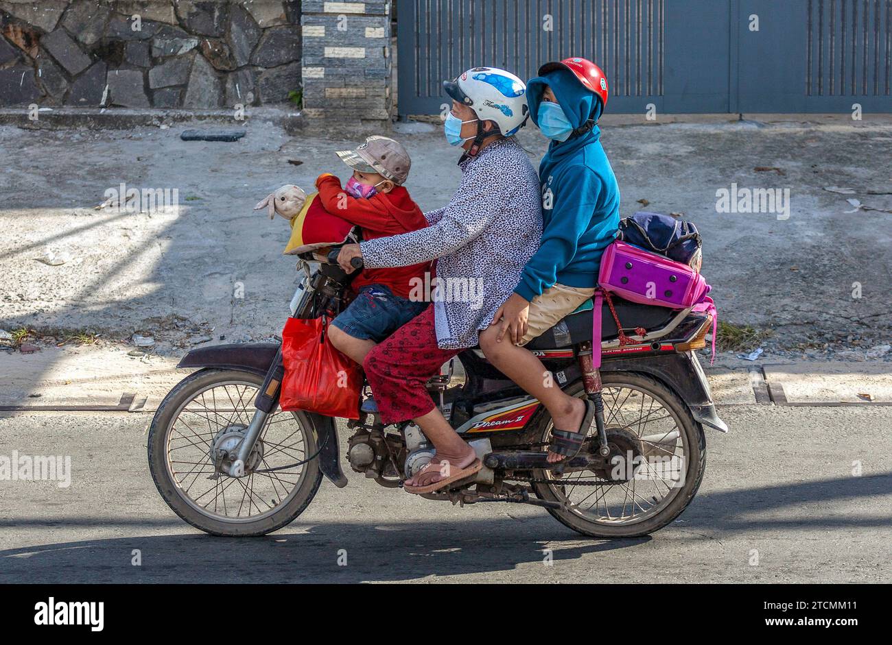 Family sharing a motorcycle, Ho Chi Minh City, Vietnam Stock Photo - Alamy
