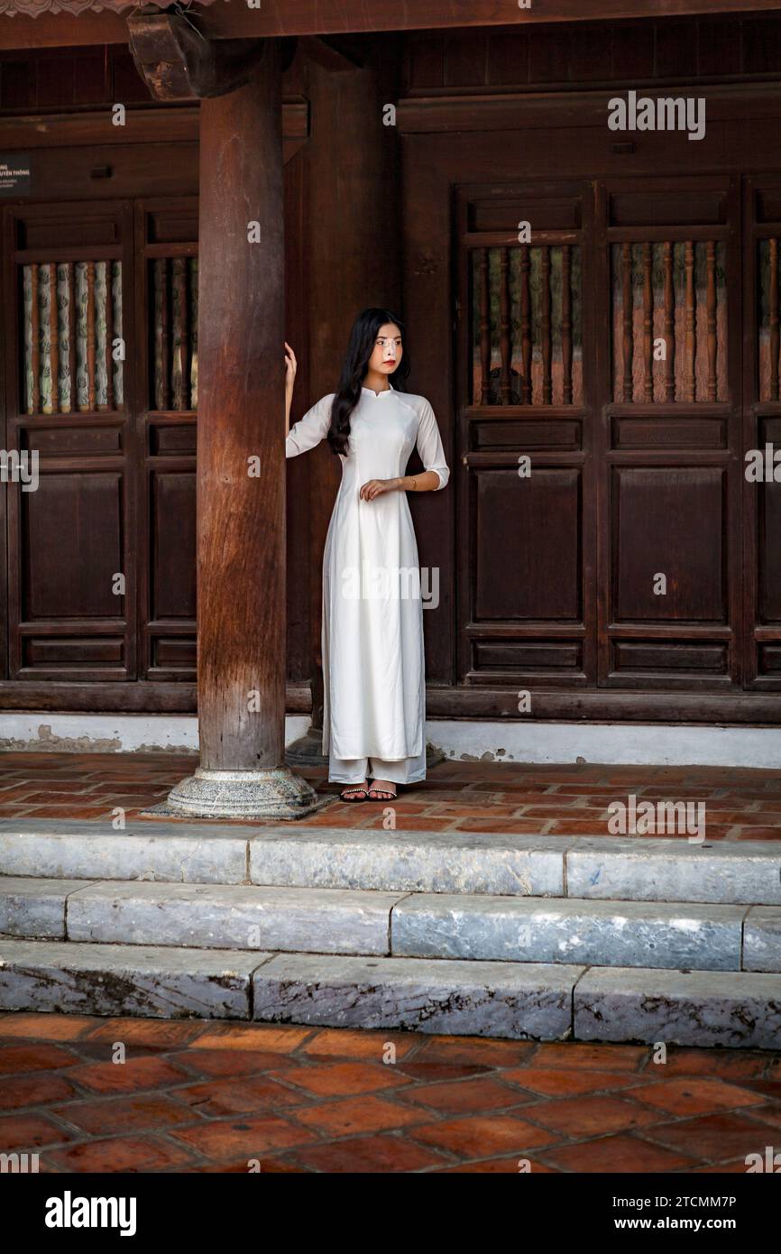 Elegant young female Vietnamese student posing for photographs on graduation day in the Temple ...